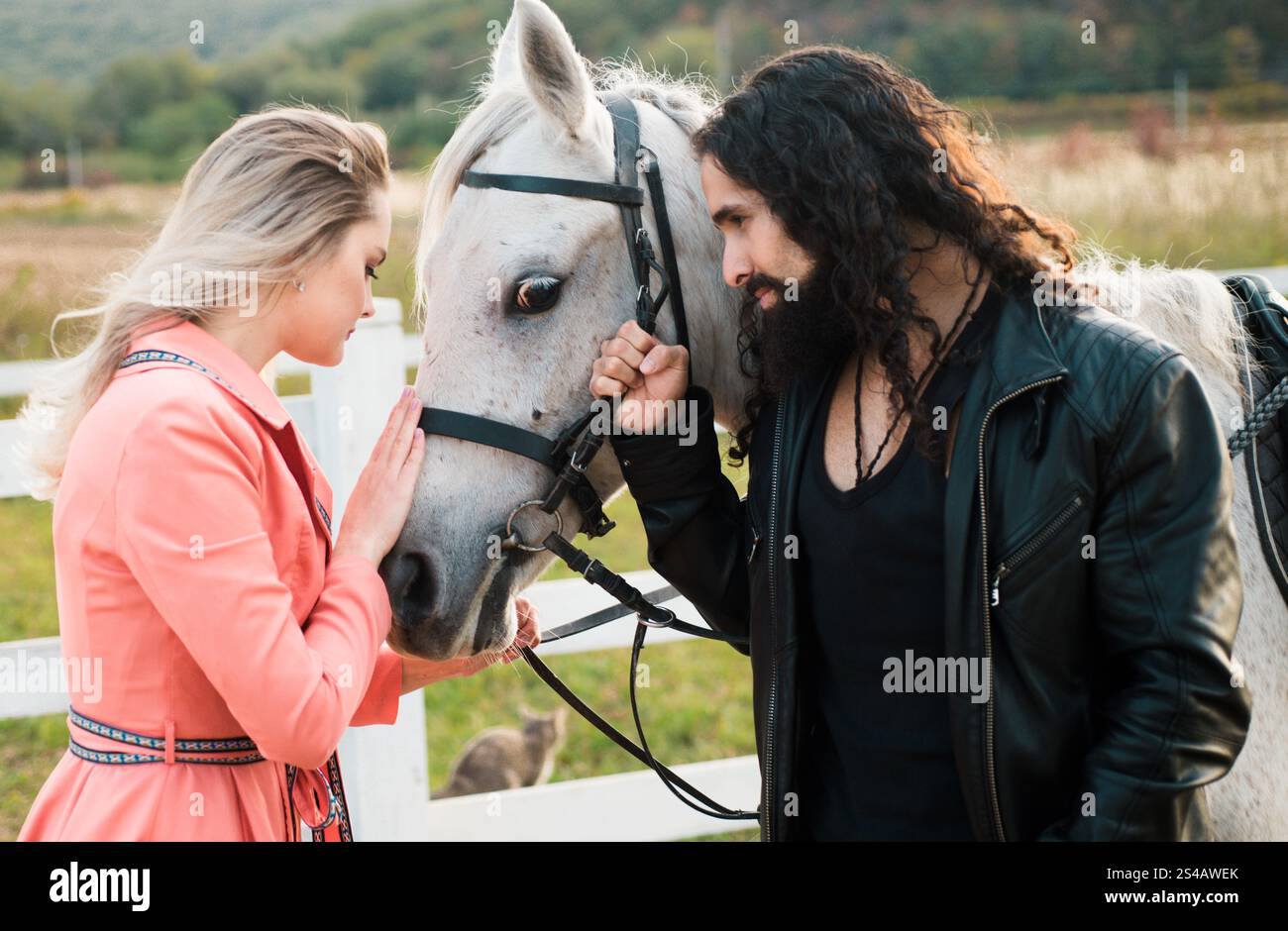 Beautiful girl wearing pink dress and guy dressed as a cowboy. People ...