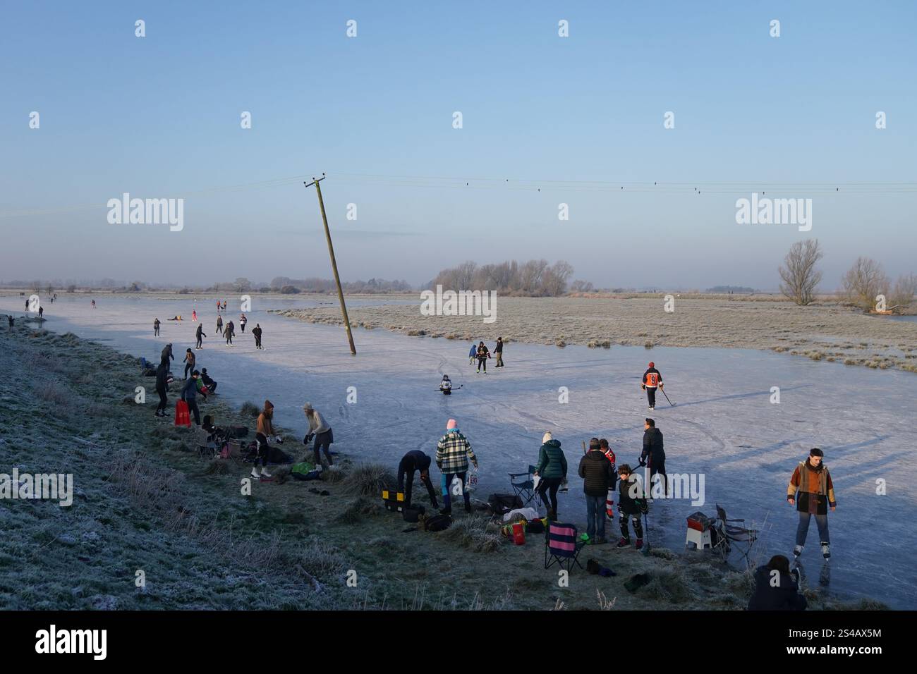 Skaters on a frozen flooded field in Upware, Cambridgeshire. The ...