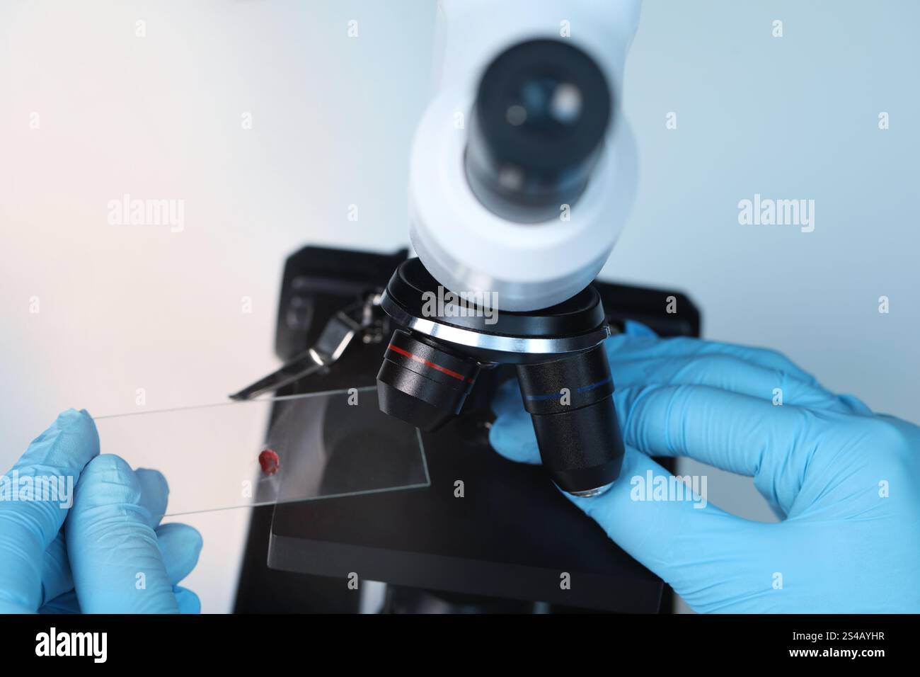 Scientist examining sample on slide under microscope, above view Stock ...