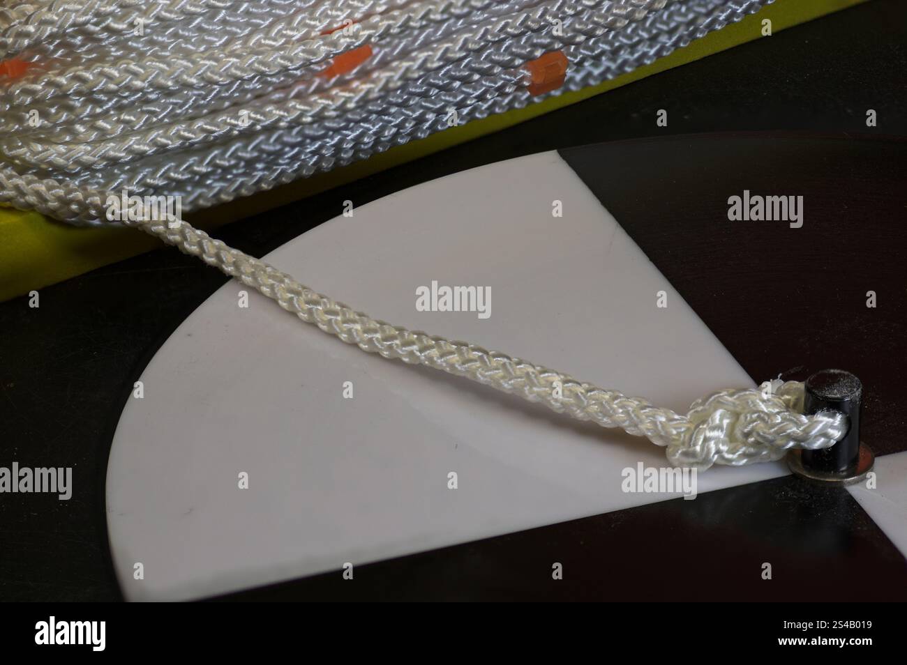 Black and White survey disk with nylon rope Stock Photo - Alamy