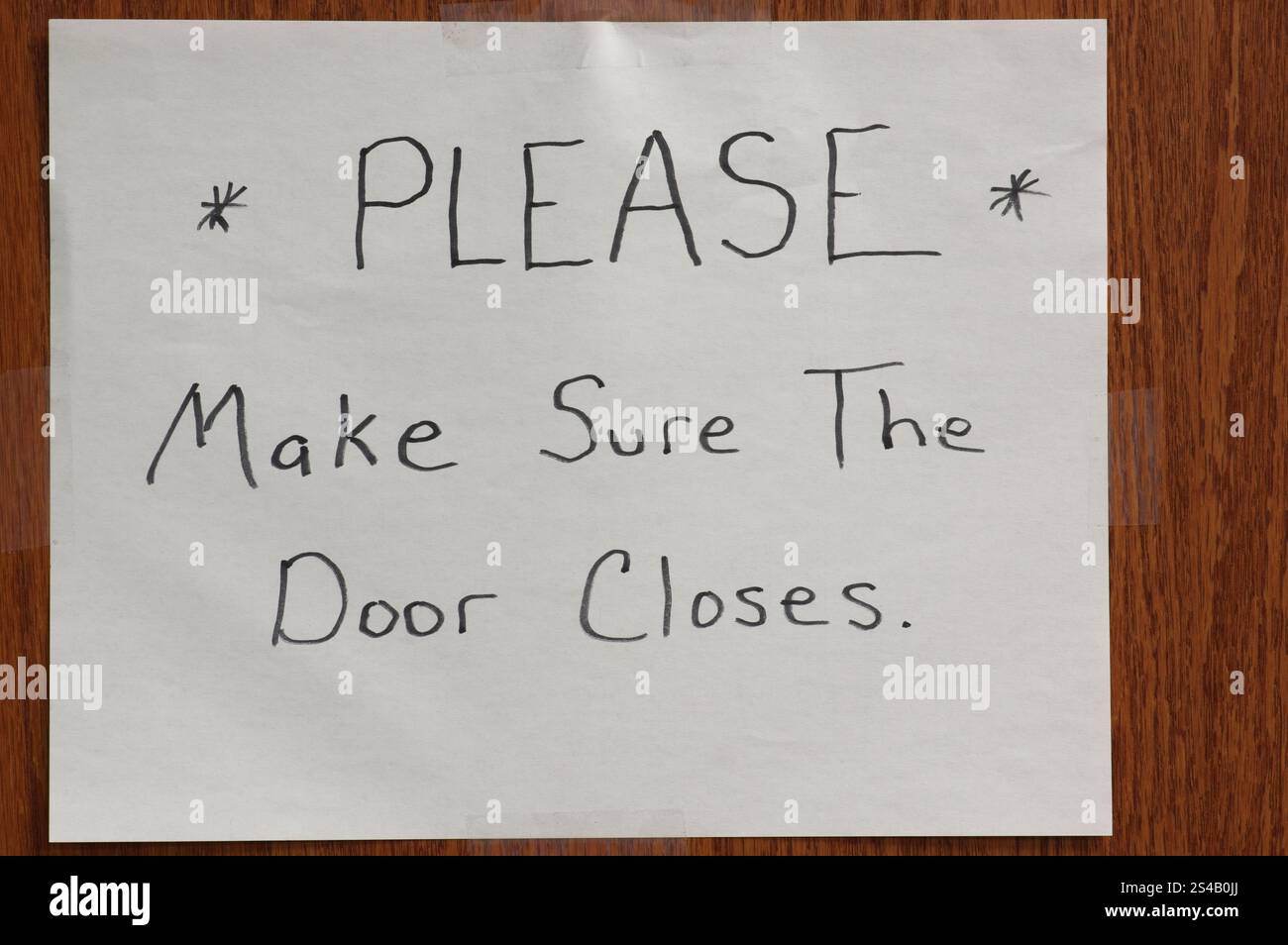 Handwritten sign on door Please Make Sure the Door Closes Stock Photo ...