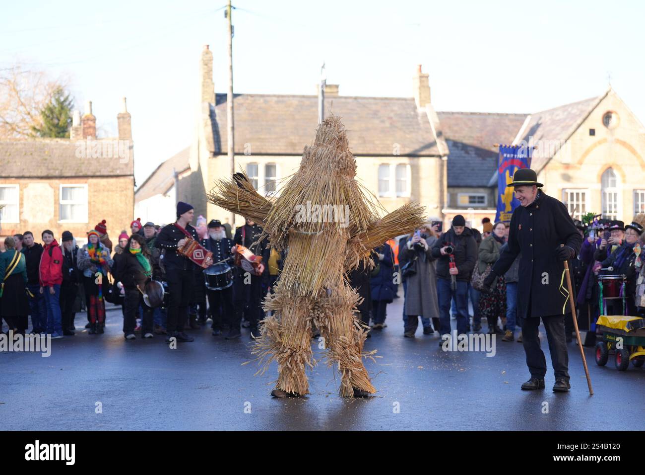 The Straw Bear is paraded through the streets accompanied by attendant ...