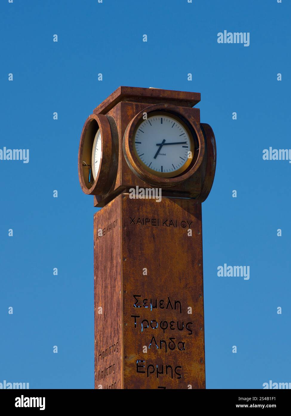 Rustic Tower Clock Against Clear Blue Sky with Greek Inscriptions Stock ...