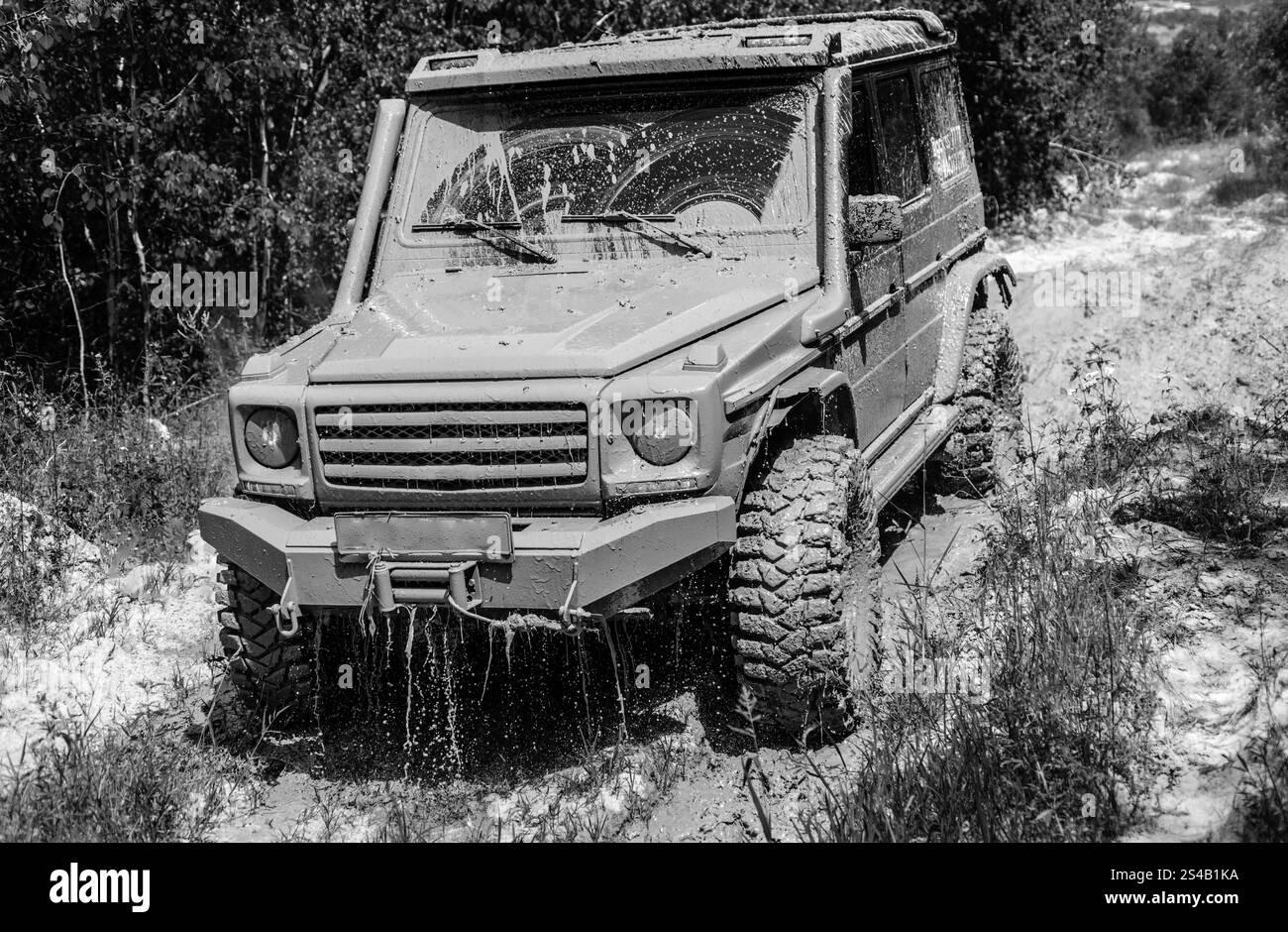 Mud and water splash in off the road racing. Tracks on a muddy field ...