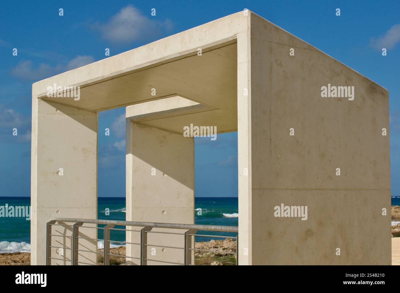 Minimalist Concrete Structure Overlooking the Ocean Under a Clear Blue ...