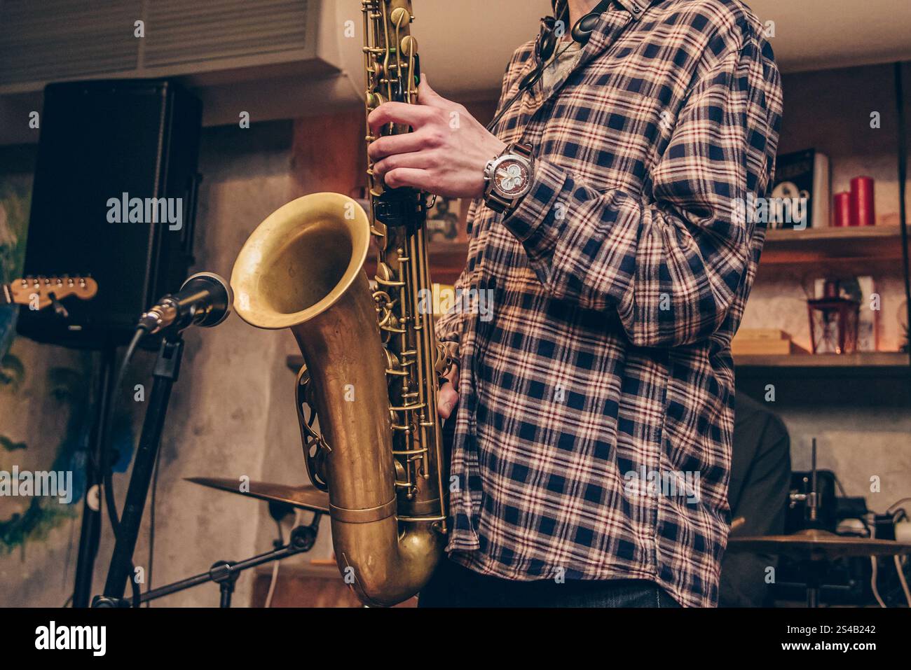 Man play a wind instrument, a musician saxophone performs at a concert ...