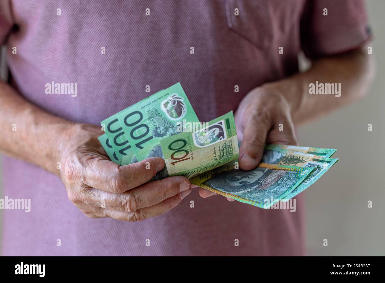 Hands man holding australian banknotes hi-res stock photography and ...
