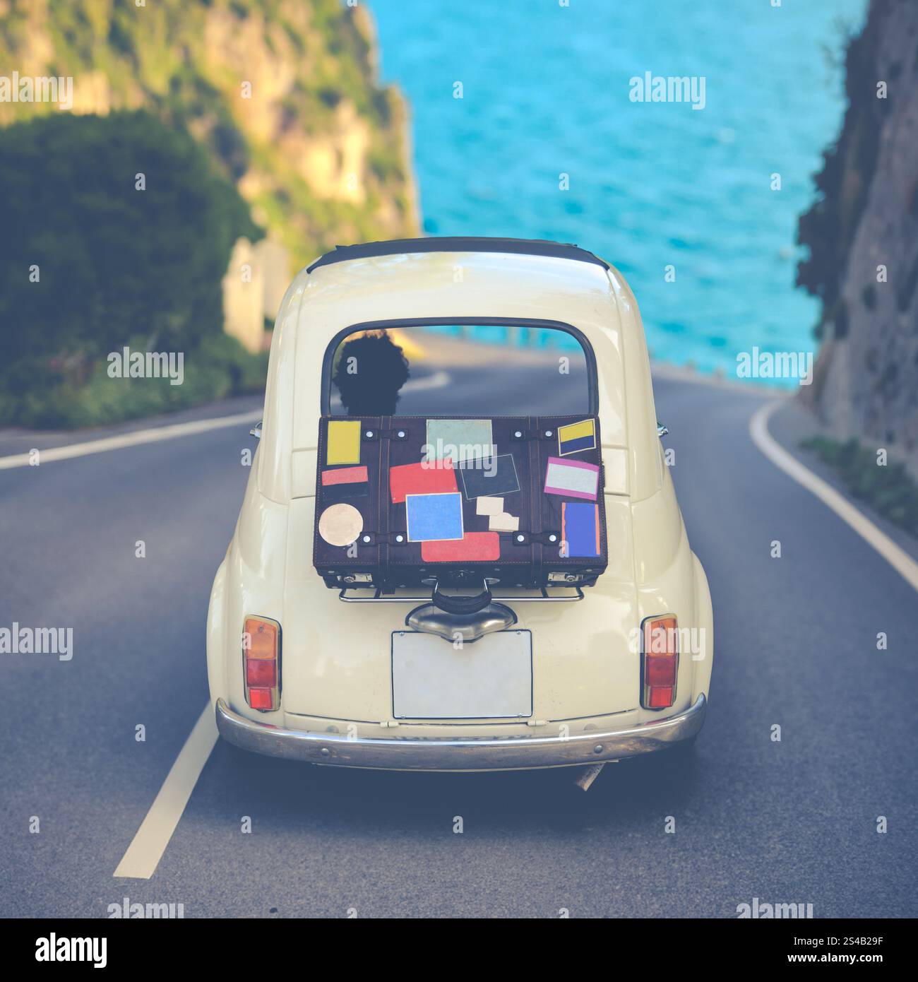 Small Cream Coloured Vintage European Car With Luggage Rack Travelling ...