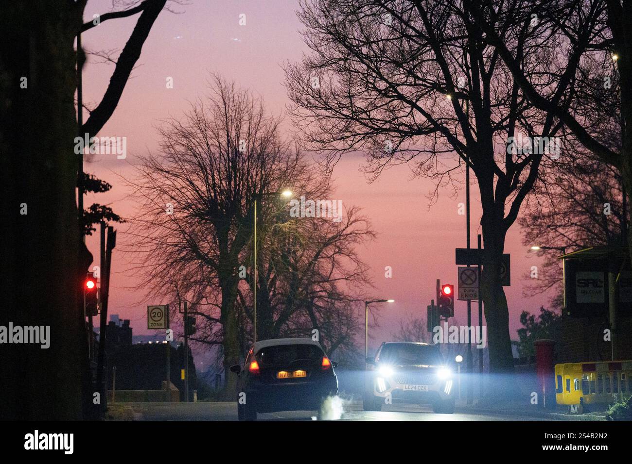 Cars pass each other at dawn at the junction of Red Post Hill and Herne ...