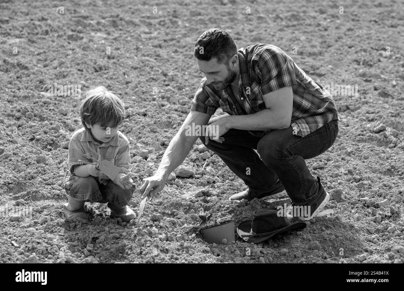 Father and son planting. Growing plants. Spring garden. Dad teaching ...
