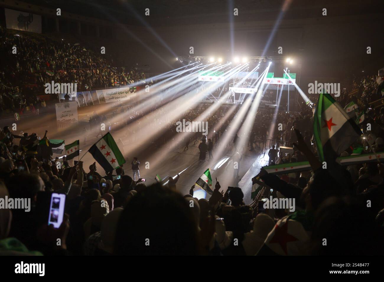 FILE.- Syrians sing and wave post-Assad flags during a concert by the ...