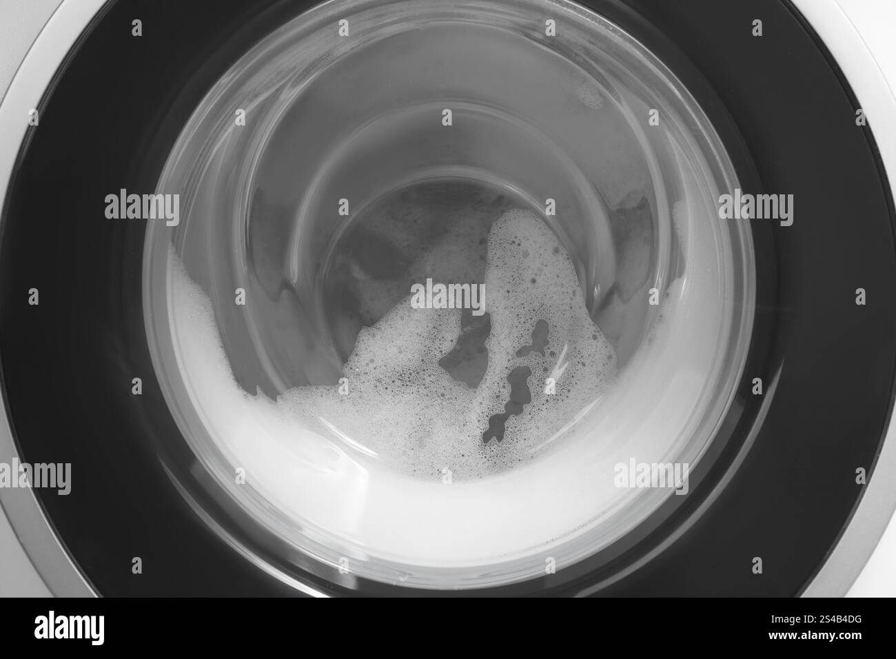 Washing machine with suds as background, closeup Stock Photo - Alamy