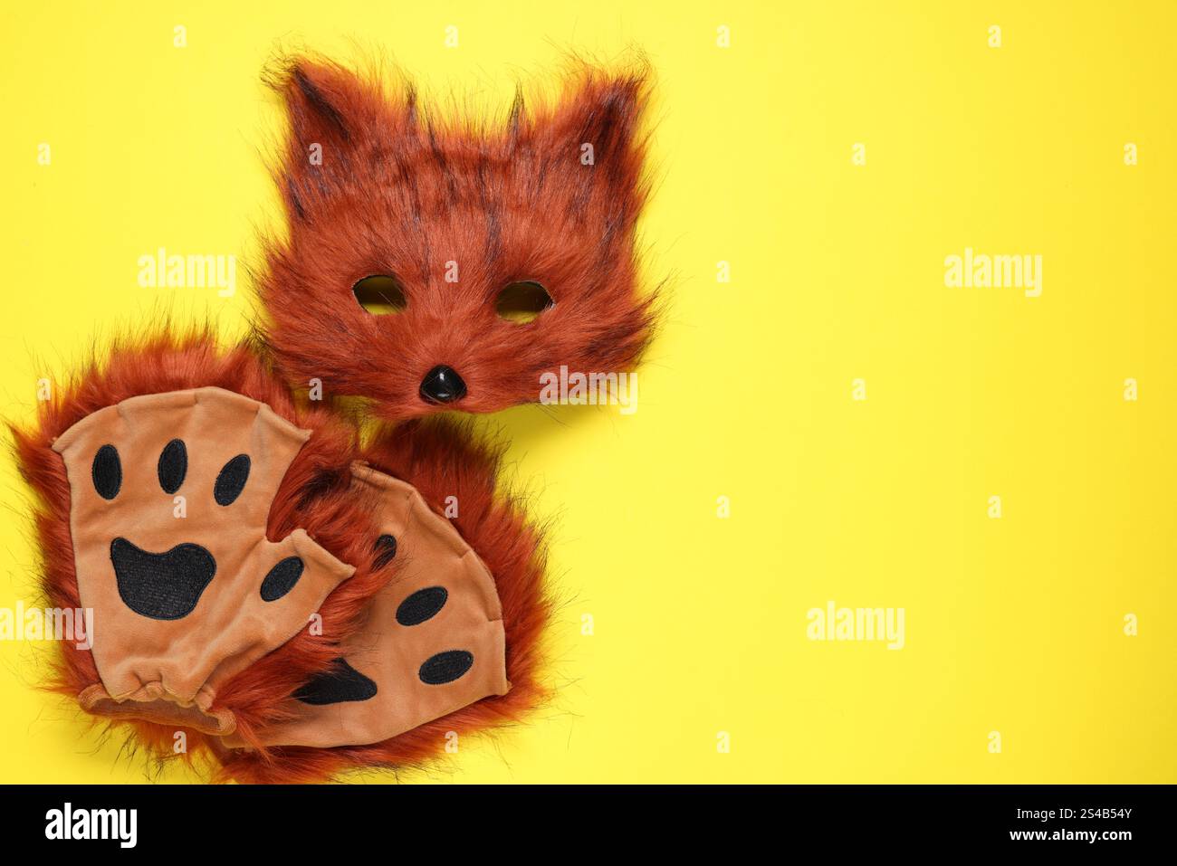 Quadrobics. Fox mask and gloves on yellow background, top view. Space ...