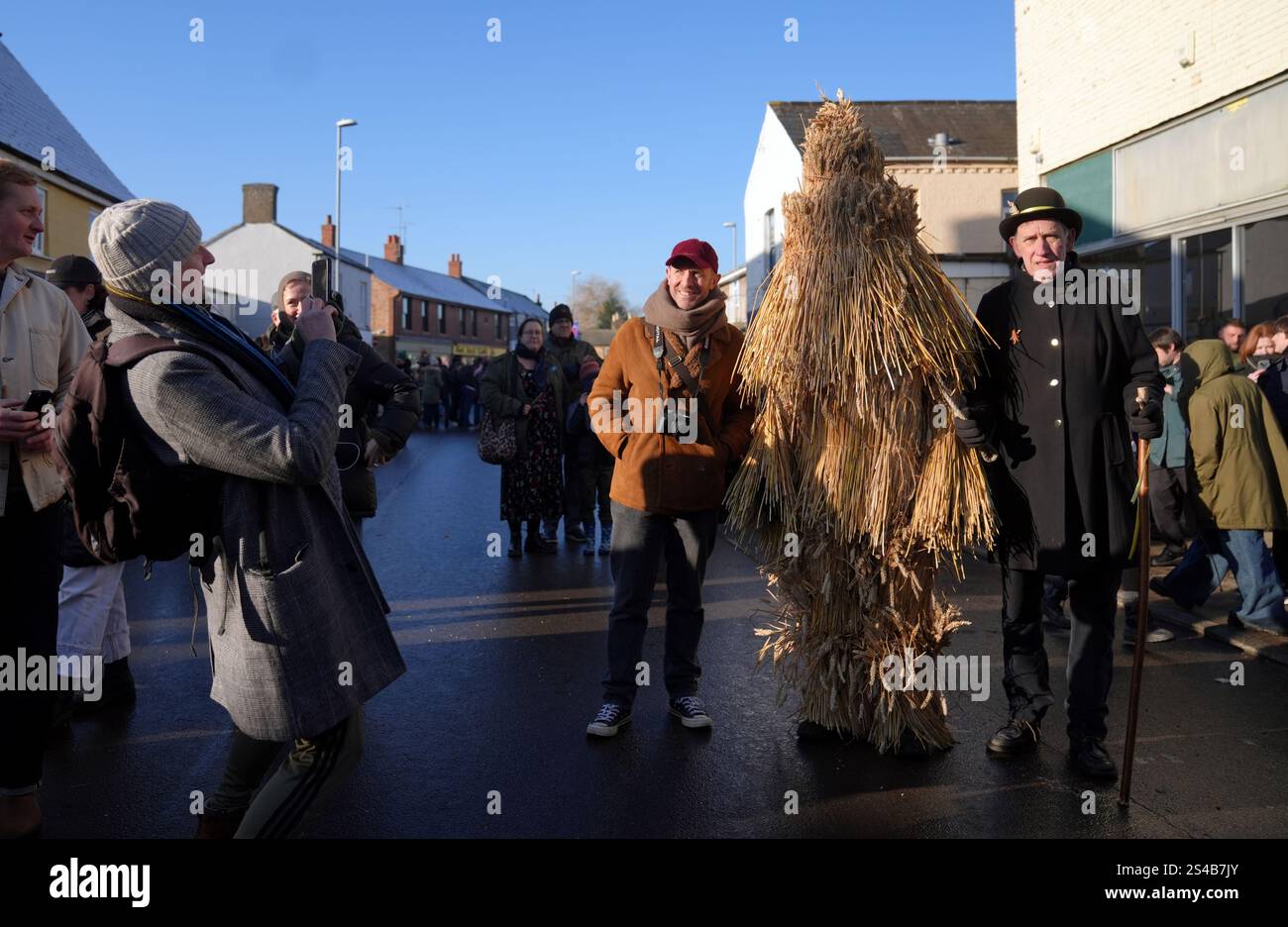 The Straw Bear is paraded through the streets accompanied by attendant ...