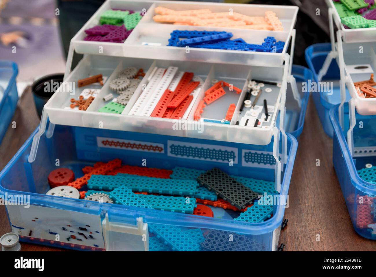 Parts of colored children construction set are in white case, toys in ...