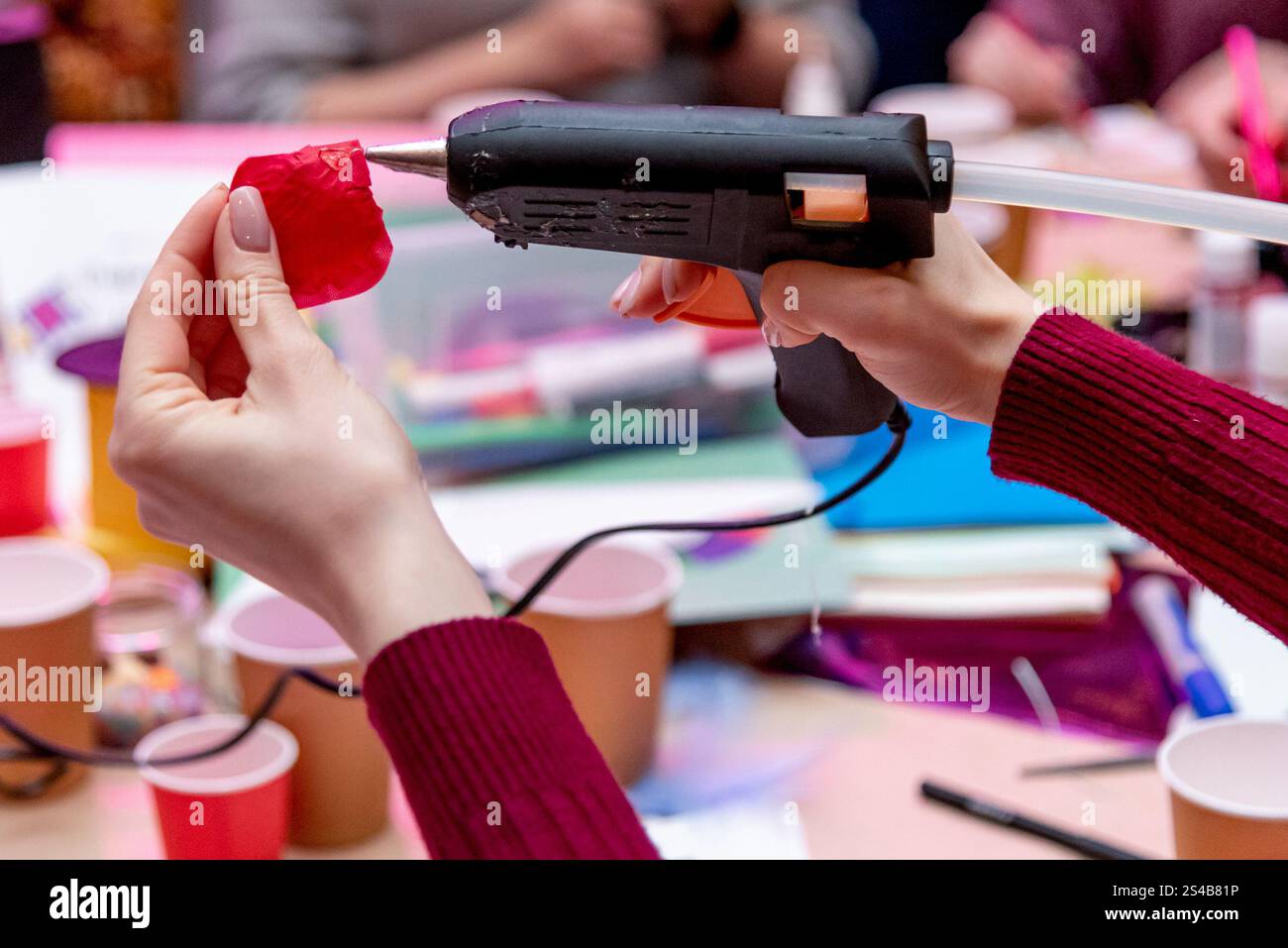 Child makes a craft from colored paper, kid draw in kindergarten ...