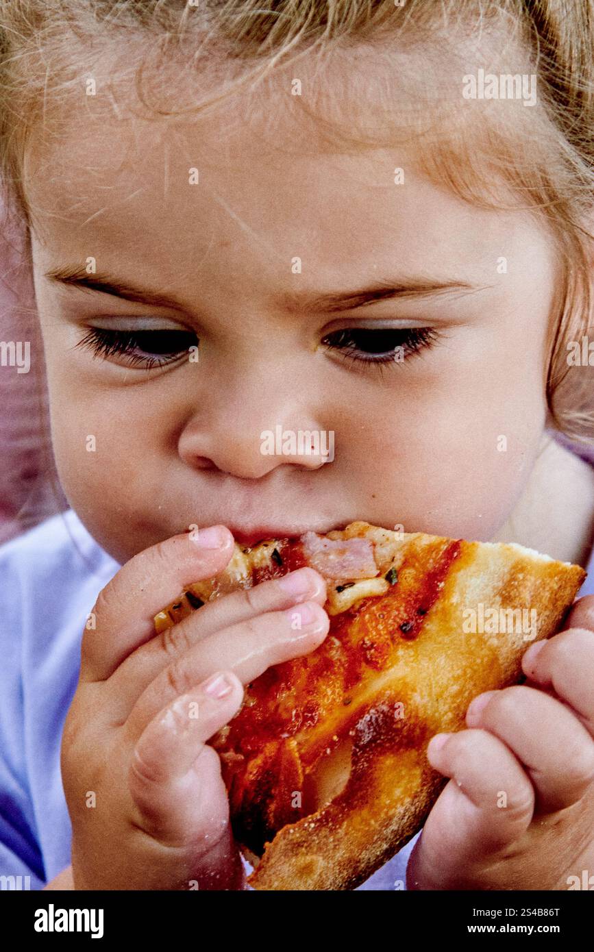 Little Girl Toddler Eating Biting piece Pizza With Cheese Close Up ...