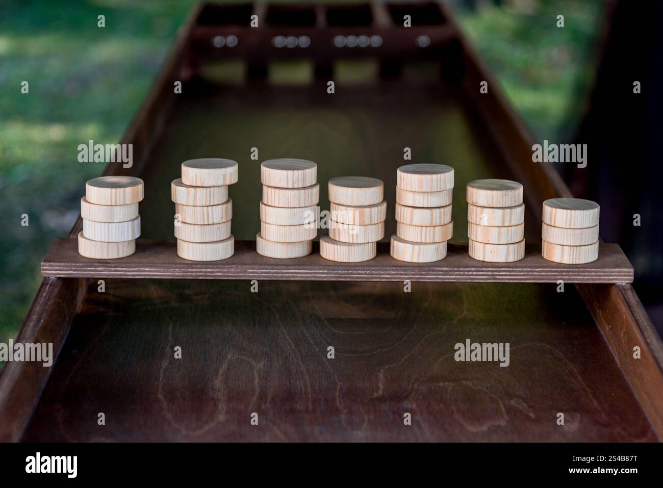 Wooden plank with round chips board game for two Stock Photo - Alamy