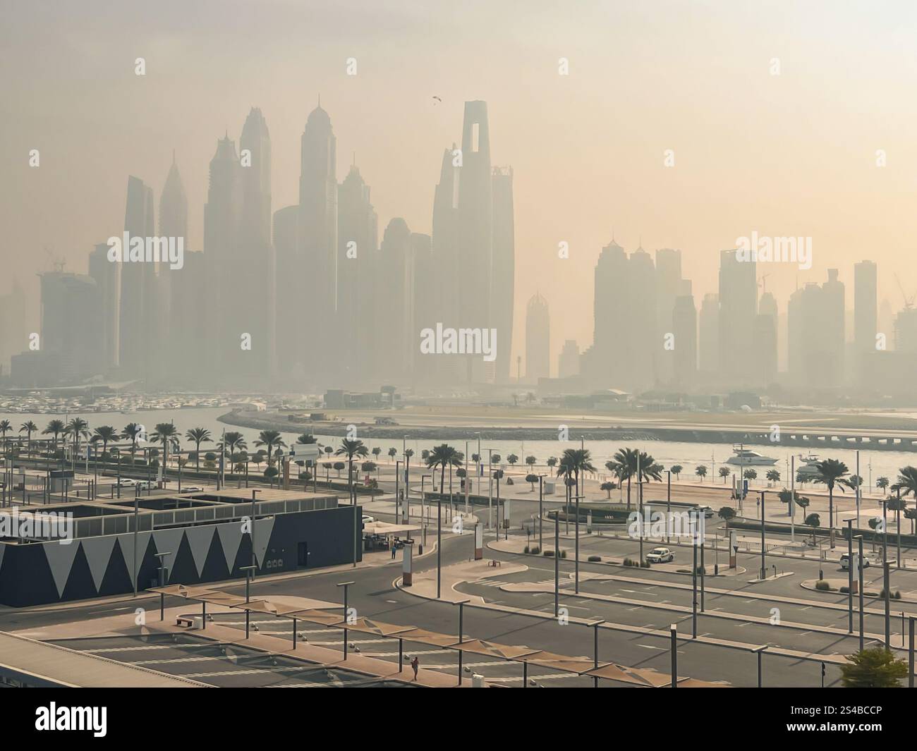 The iconic skyline of Dubai shrouded in a misty haze during sunset ...