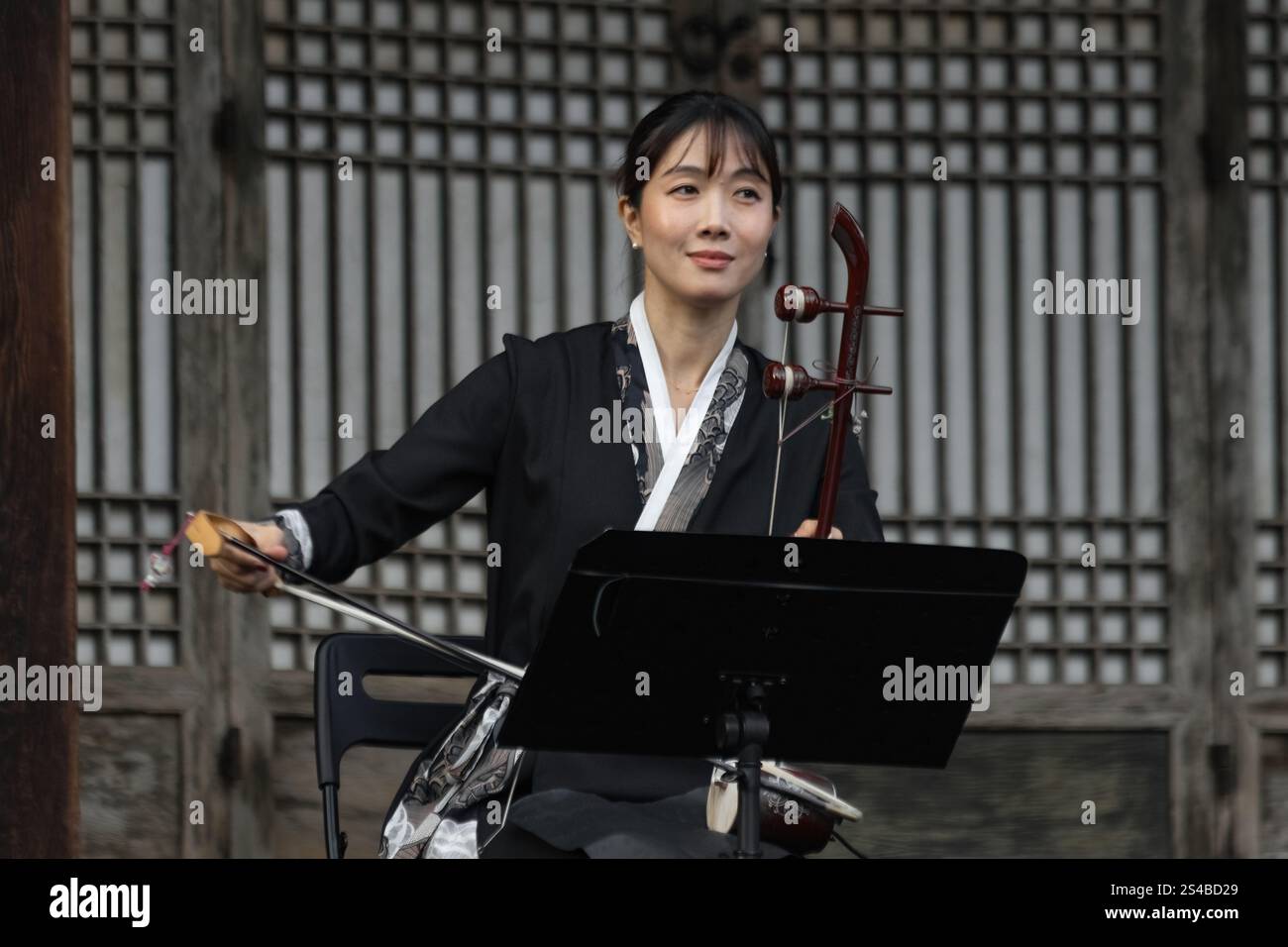 Korean woman violoncellist on the stage during the concert in Seoul ...