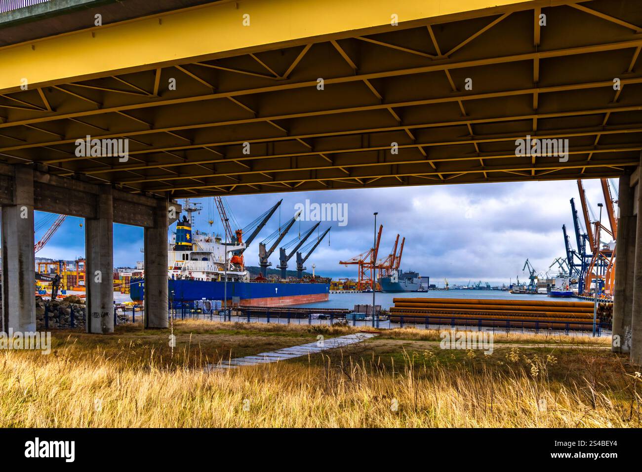 Tall cranes in the port, unloading goods from containers from ships, cargo port in Gdynia Stock ...