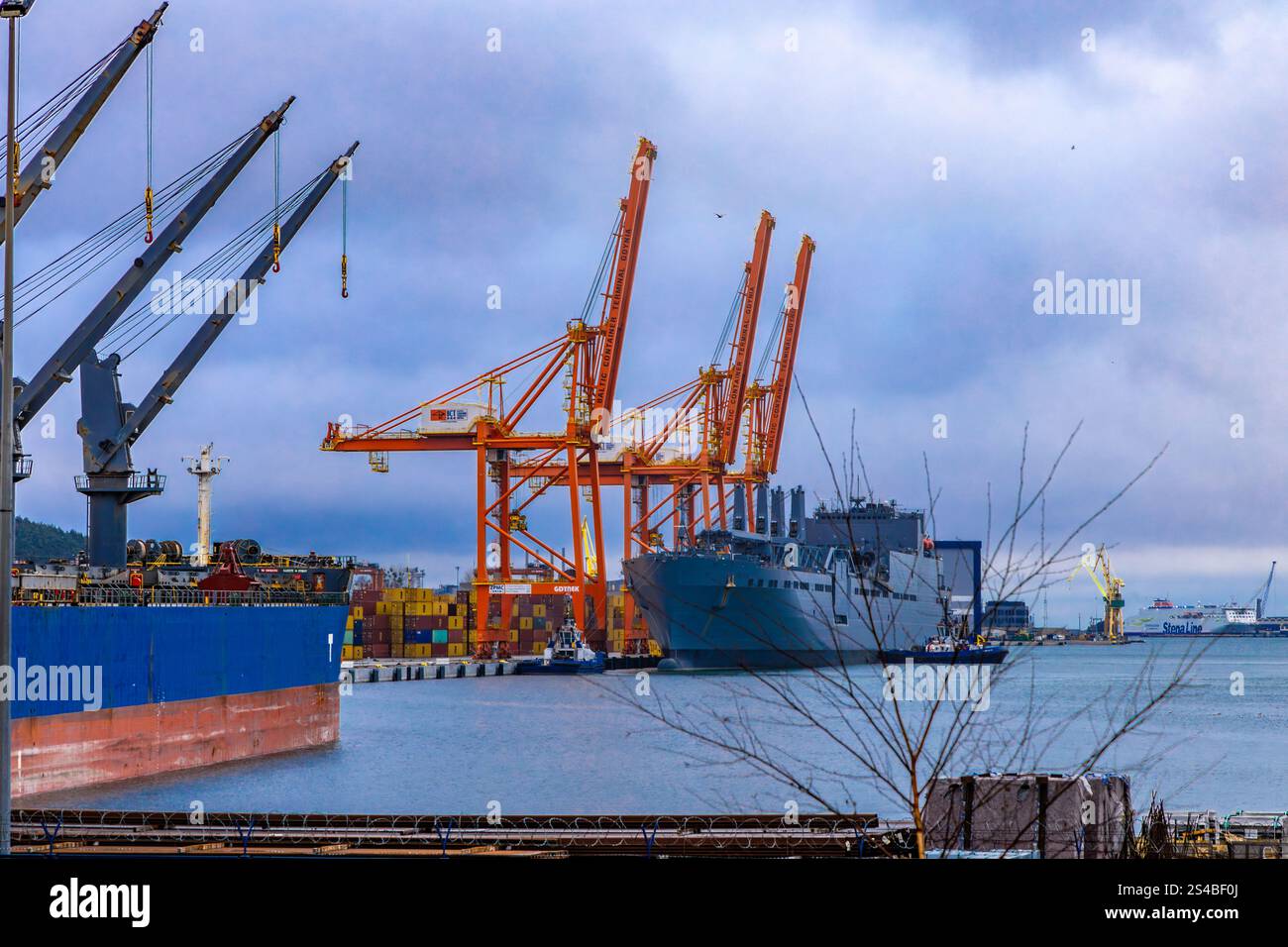 Tall cranes in the port, unloading goods from containers from ships, cargo port in Gdynia Stock ...