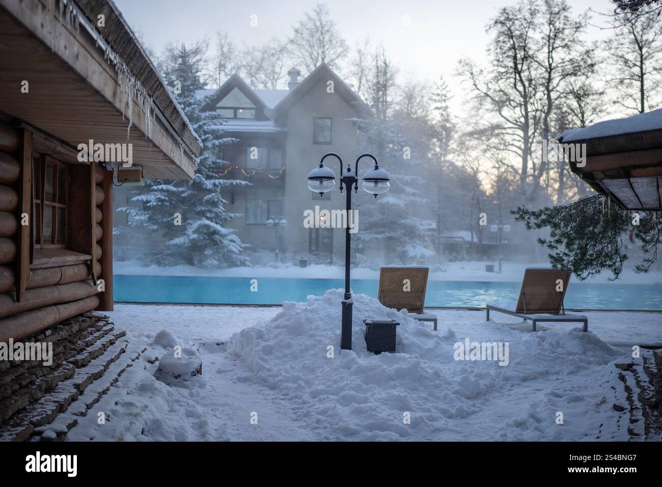 Open-air swimming pool with warm water, loungers and wooden Russian ...