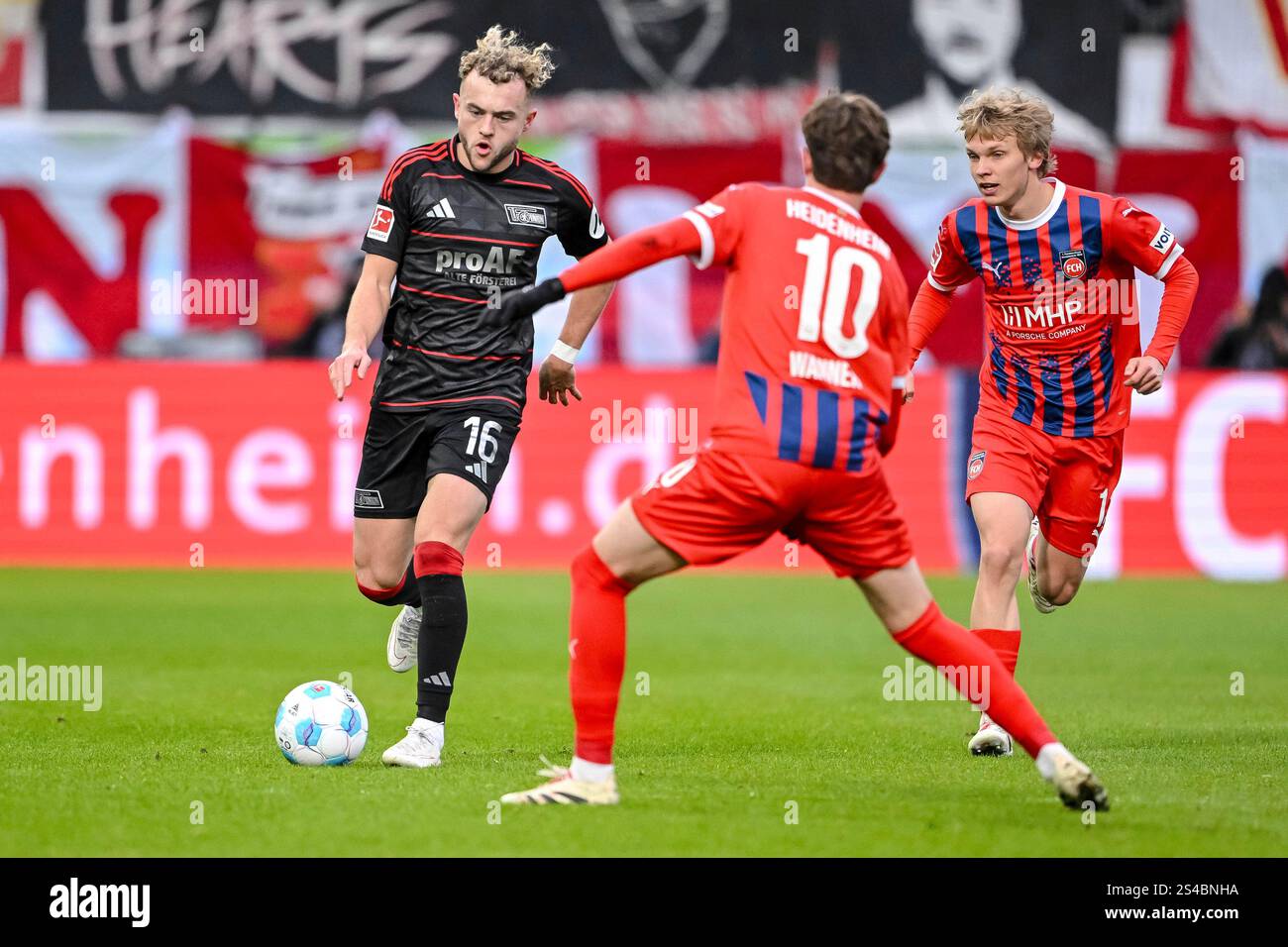 Berlin's Benedict Hollerbach is challenged by Heidenheim's Paul Wanner ...