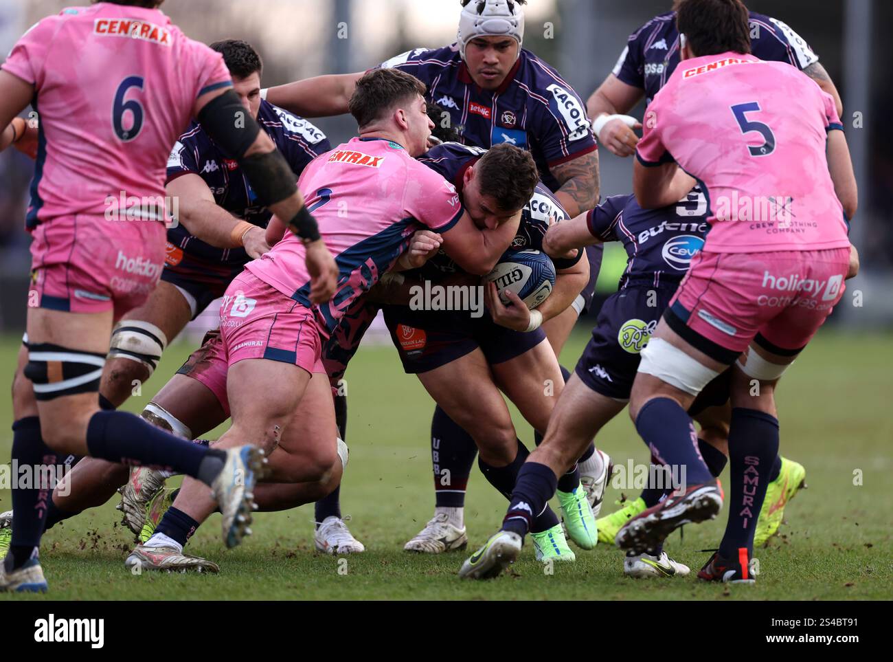 Bordeaux Begles' Rohan Janse van Rensburg (centre) gets tackled during ...