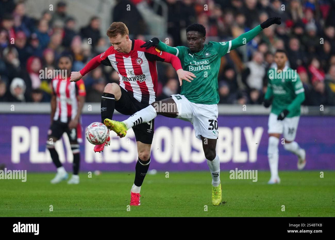 Brentford's Sepp van den Berg (left) and Plymouth Argyle's Michael ...