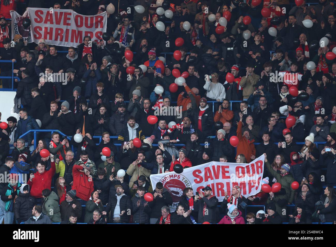 London, UK. 11th Jan, 2025. Morecambe fans with banners and balloons in ...