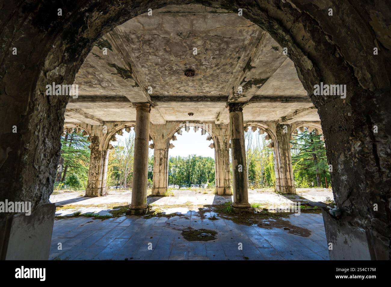 Perspective of ruined palace veranda framed by ancient arches and ...