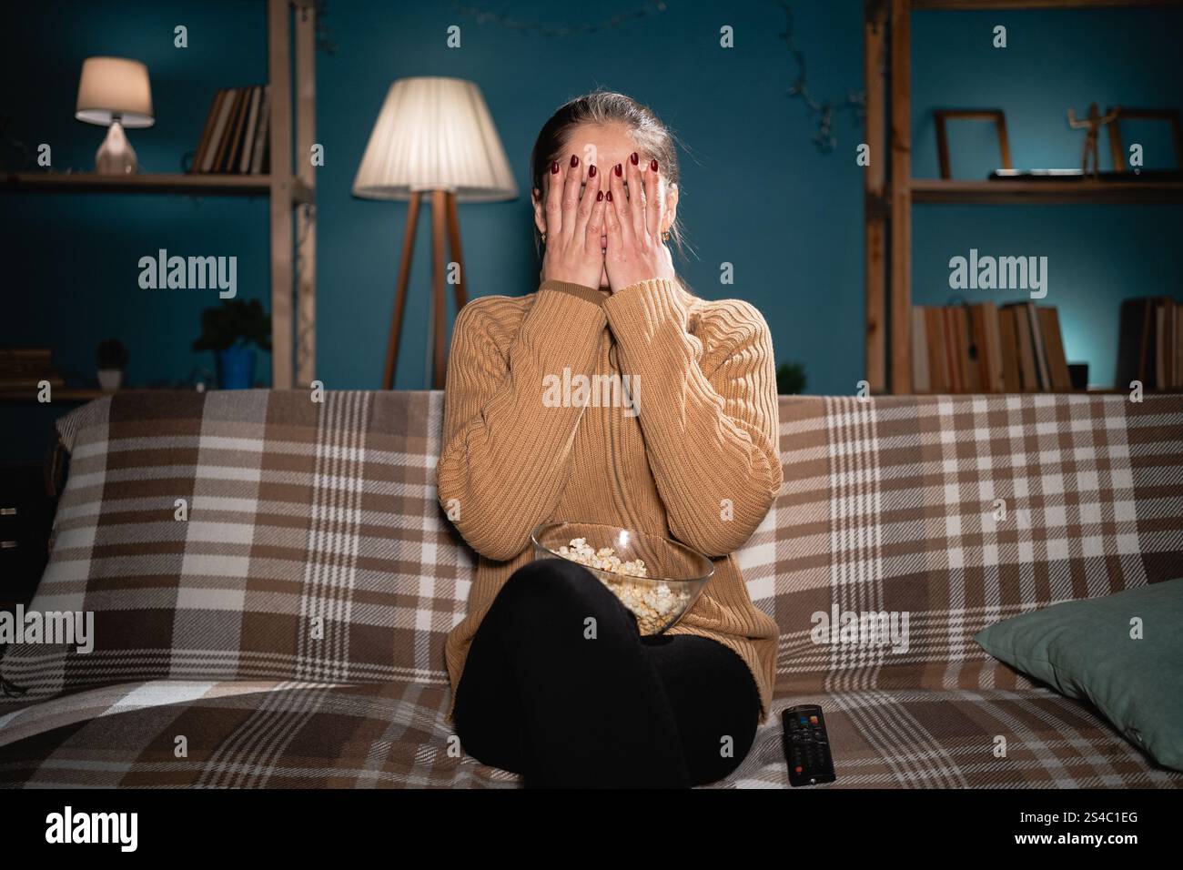 tv horror. Shocked woman closing faces with hands frightened of ...