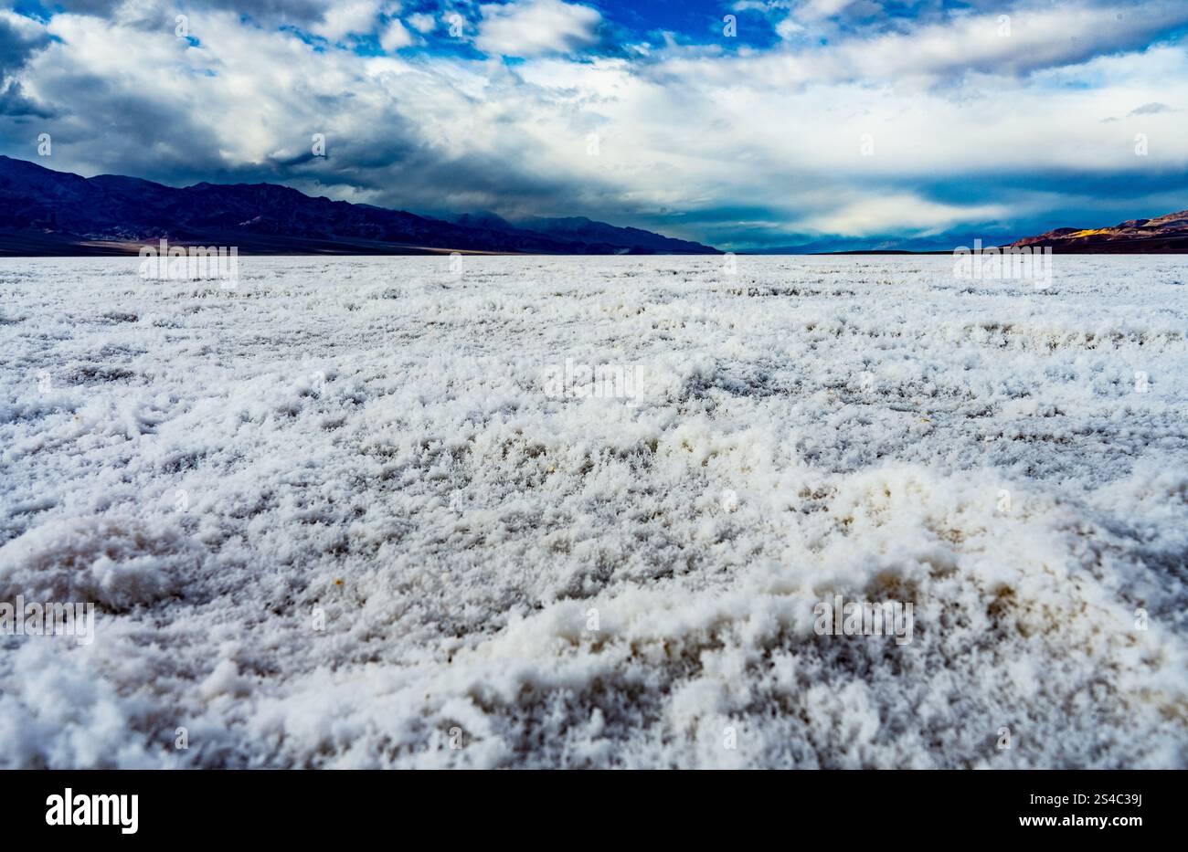Salt-encrusted terrain at Badwater Basin in Death Valley, with storm ...