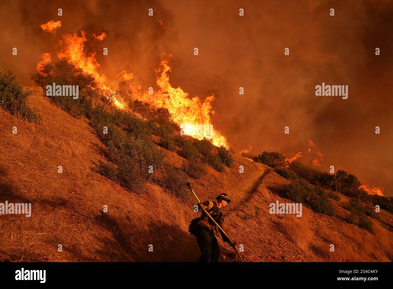 A firefighter battles the Palisades Fire in Mandeville Canyon Saturday ...