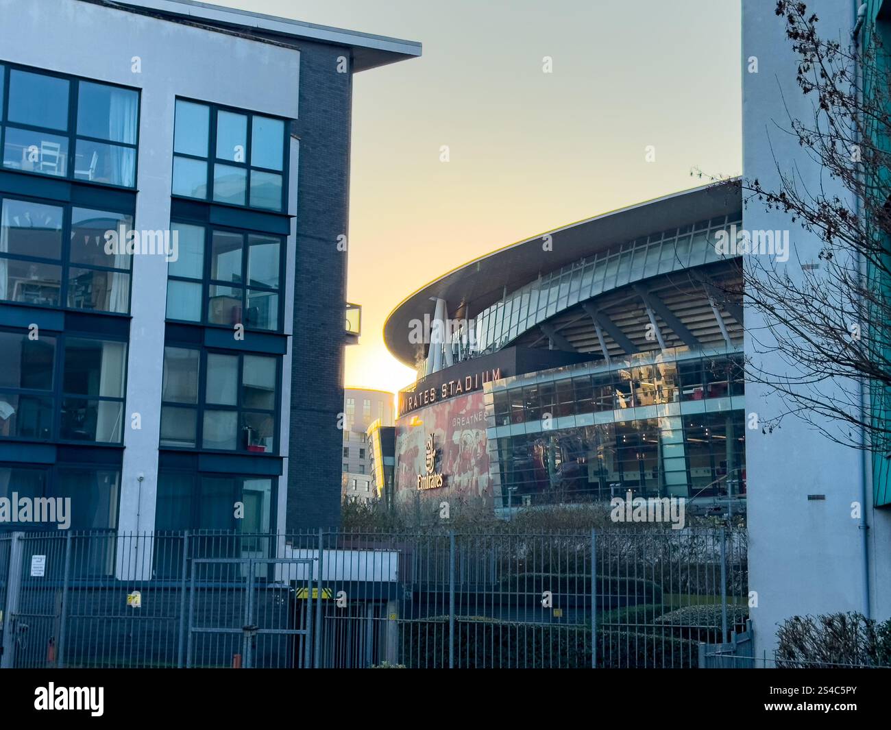 Sunset captured between buildings in Highbury, London. Setting sun ...