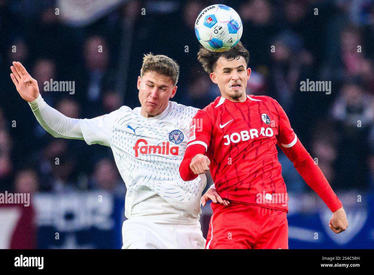 Holstein Kiel's Phil Harres, left, in action against Freiburg's Max ...