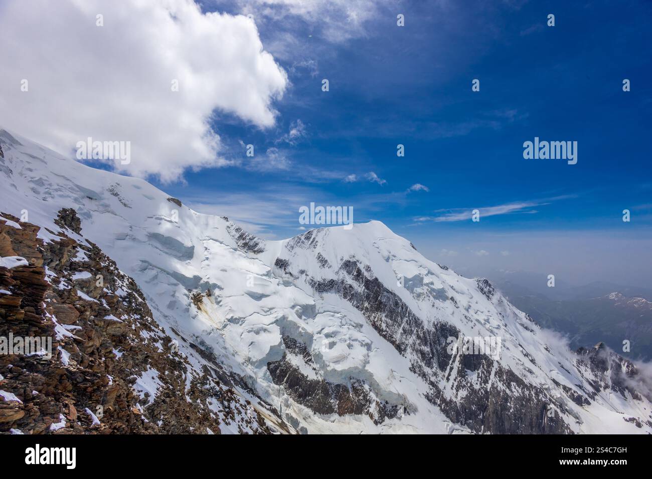 Snow mountain summits and white ice glacier in the Alps. Mont Blanc climbing route and views ...
