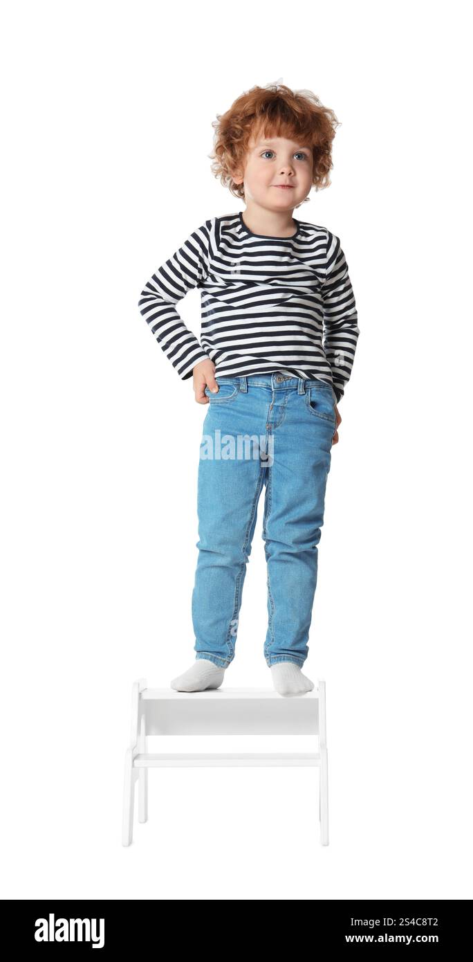 Little boy standing on step stool against white background Stock Photo ...