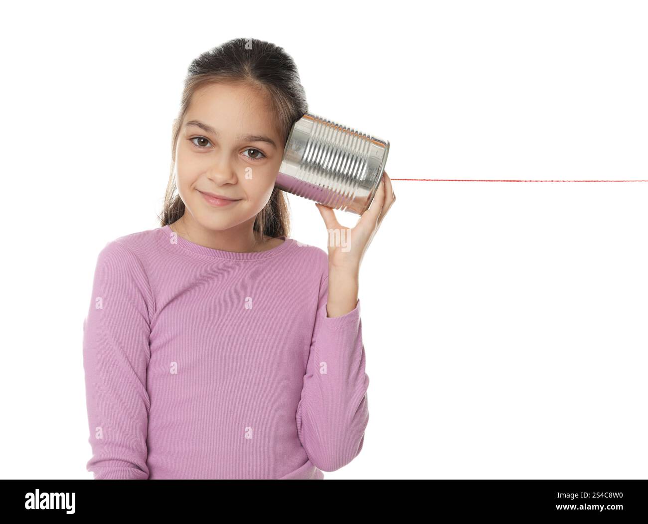 Girl using tin can telephone on white background Stock Photo - Alamy