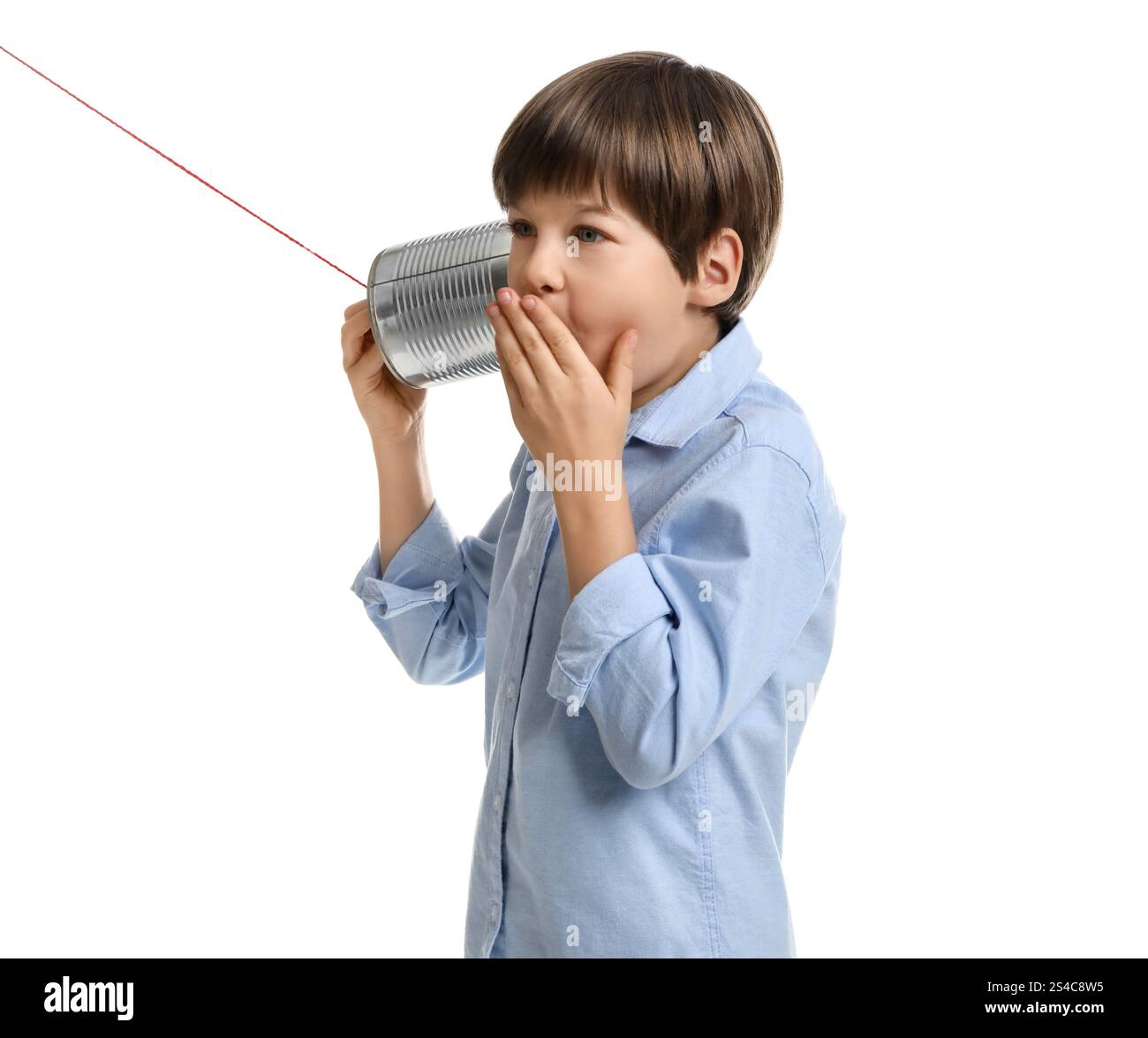 Boy using tin can telephone on white background Stock Photo - Alamy