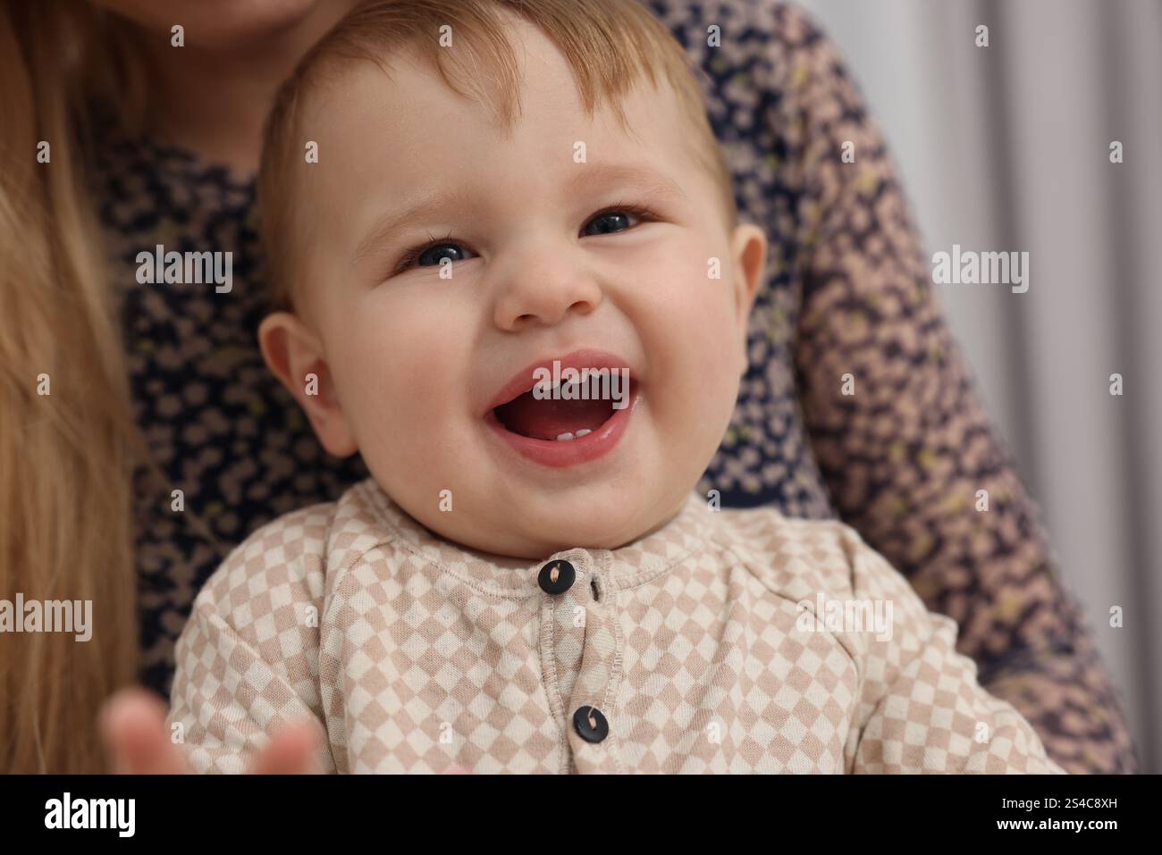 Mother holding her little baby at home Stock Photo - Alamy