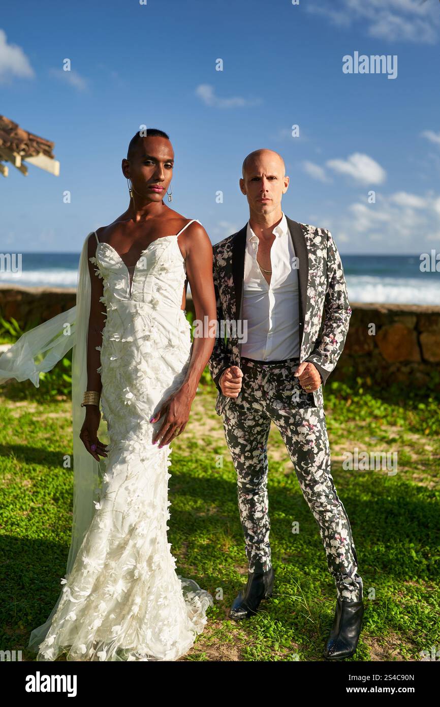 Ambiguous gender fluid ethnic black person in white dress with partner ...