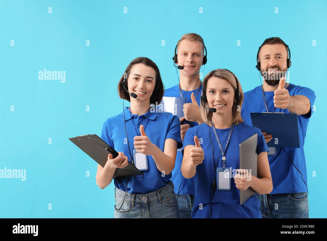 Technical support call center. Team of friendly operators showing ...