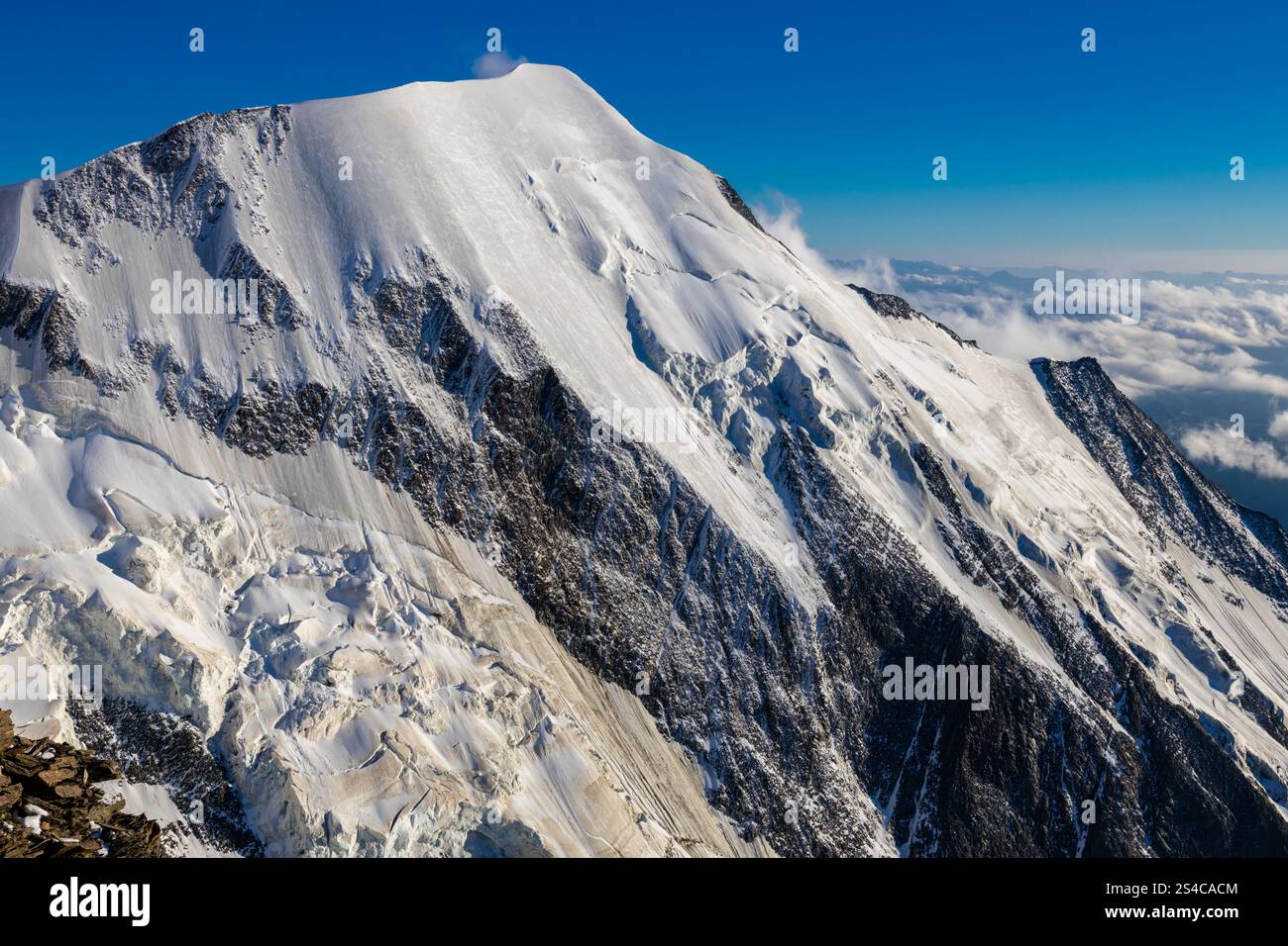 Snow mountain summits and white ice glacier in the Alps. Mont Blanc climbing route and views ...