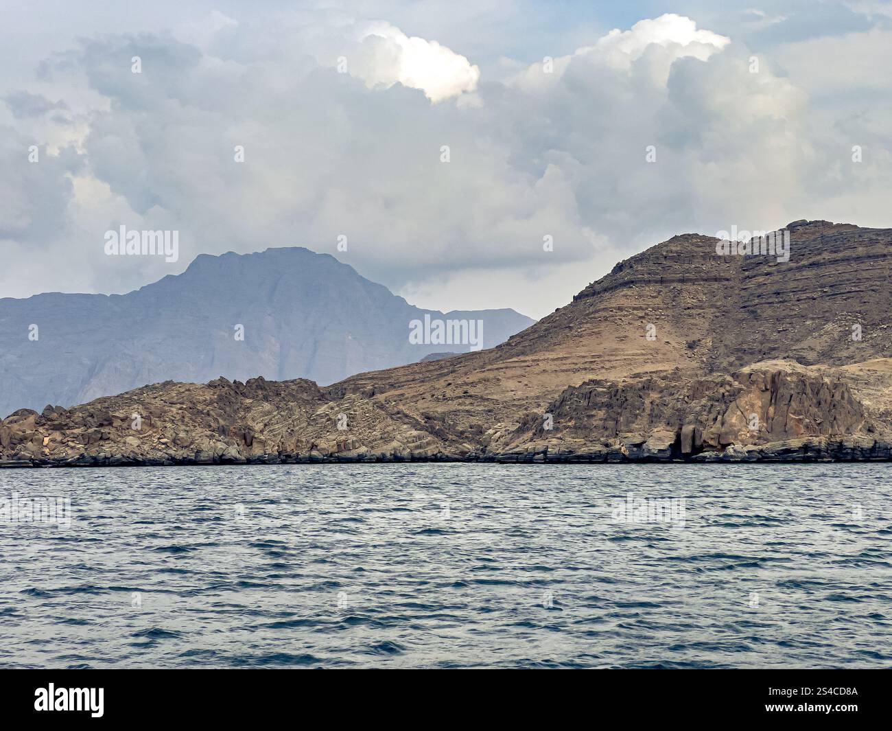 The rugged mountains meet the tranquil waters of the Arabian Sea in ...