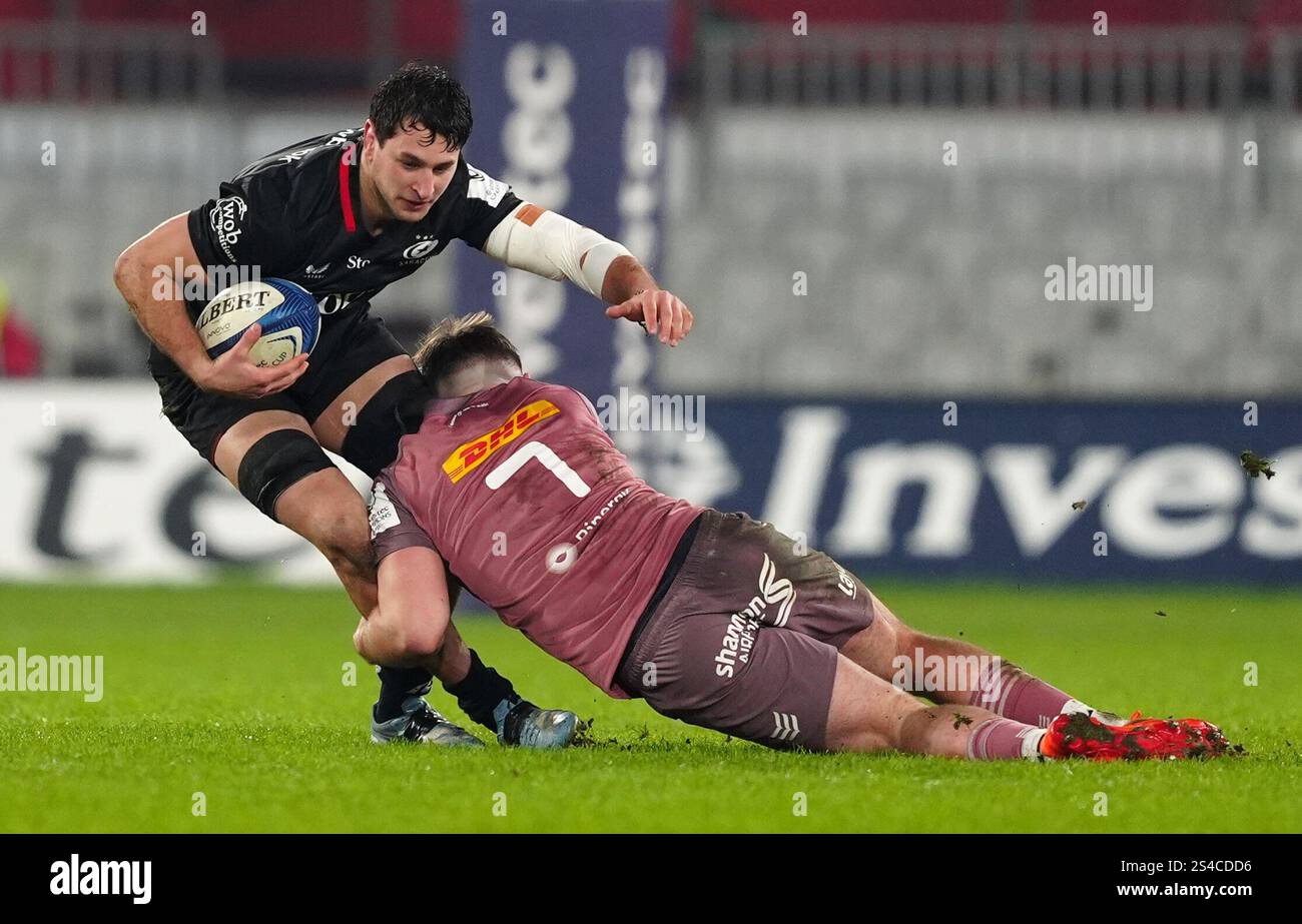 Saracens' Juan Martin Gonzalez is tackled by Munster's Alex Kendellen ...