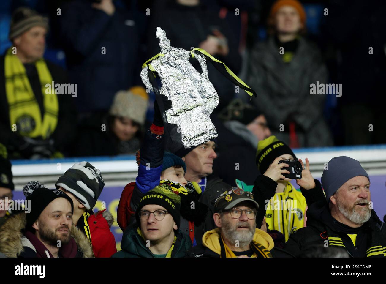 A Harrogate Town fan holding a tinfoil FA Cup trophy ahead of the ...