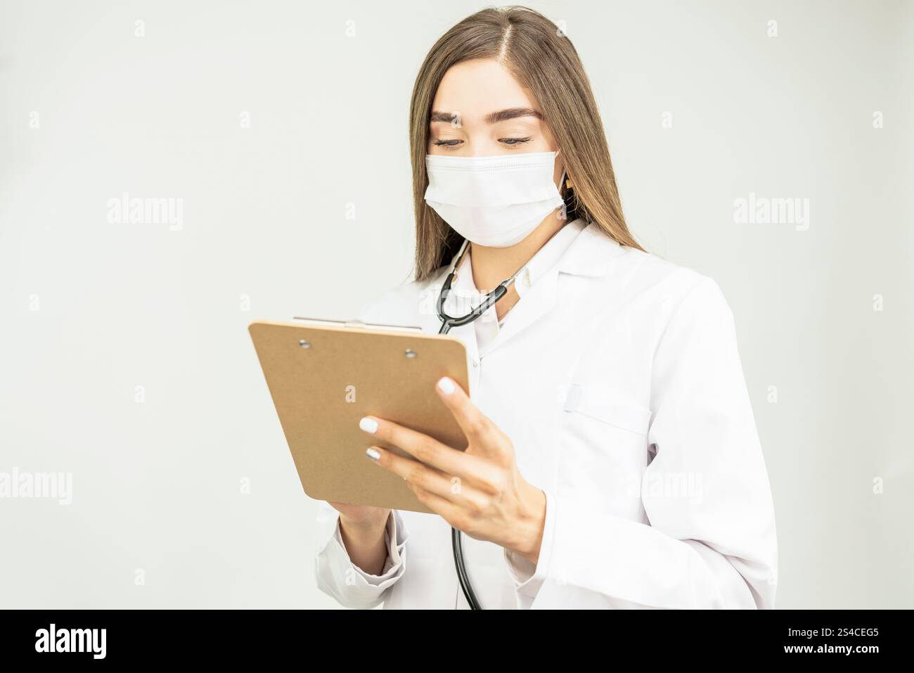 Doctor woman taking notes on clipboard. Close-up of a unrecognizable ...