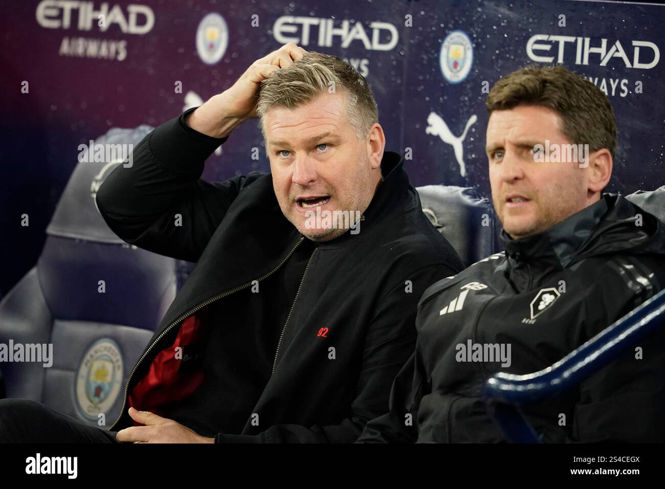Salford head coach Karl Robinson, left, waits for the start of the ...